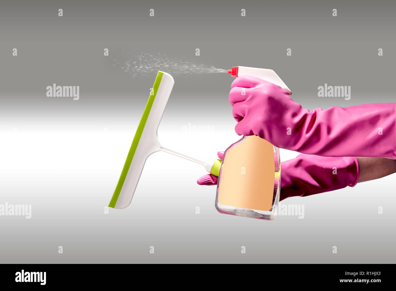 Hand in gloves using cleaning spray and cleaning tools on bright ...