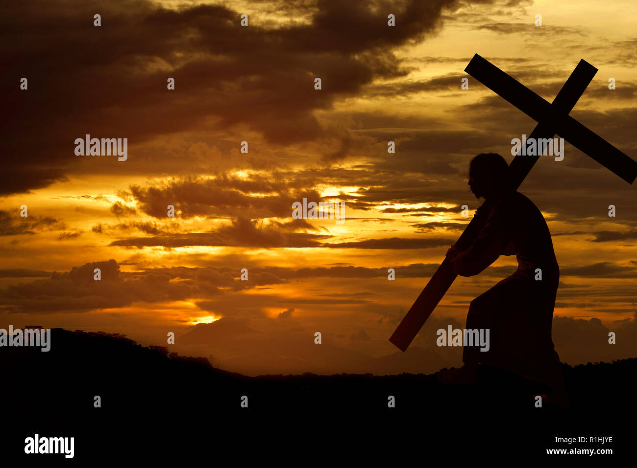 Silhouette of Jesus christ carrying cross over sunset background Stock ...