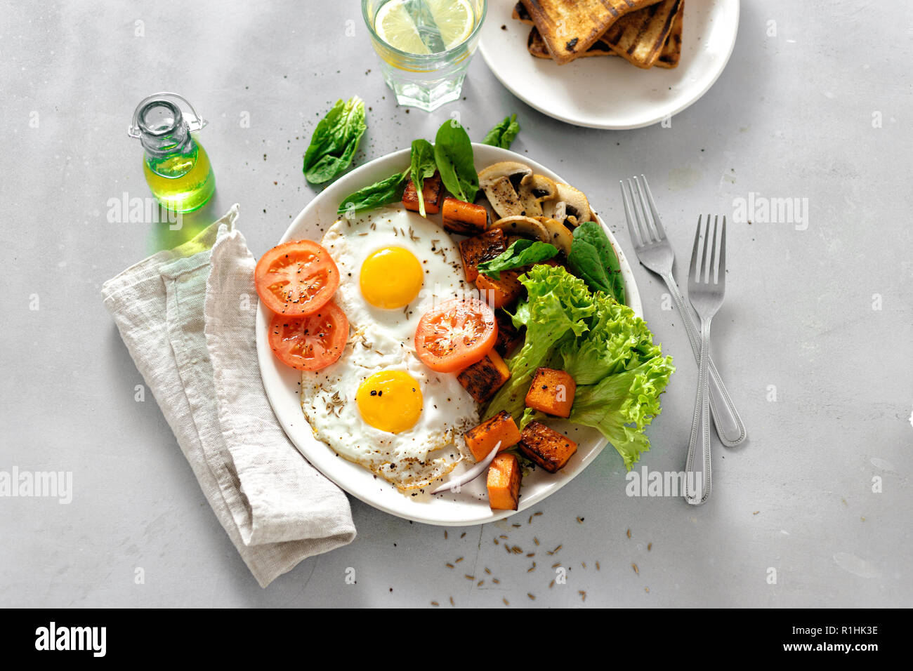 Top view breakfast table. Breakfast plate with fried eggs, vegetables ...