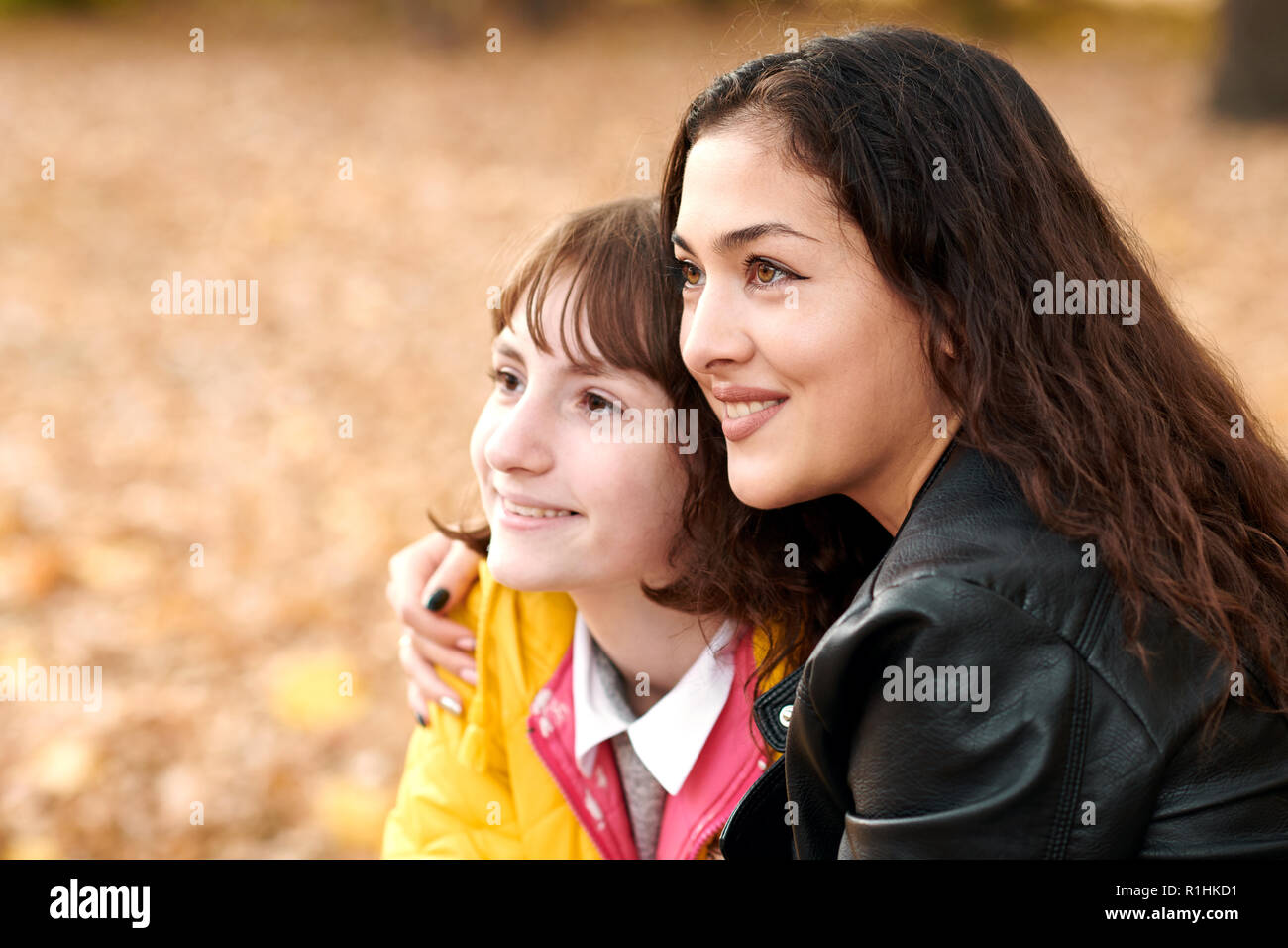 Two girls sister posing in city park hi-res stock photography and ...