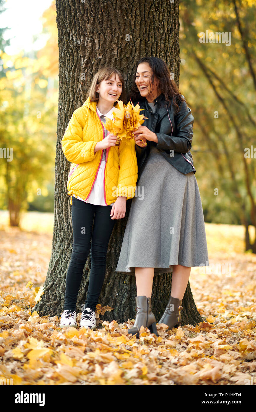 Two girls sister posing in city park hi-res stock photography and ...