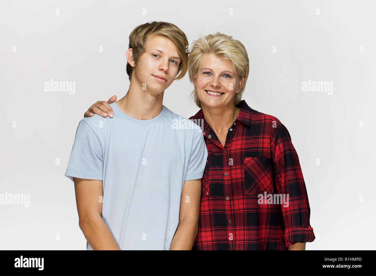 Happy and smiling mother and son. Loving family portrait against white ...