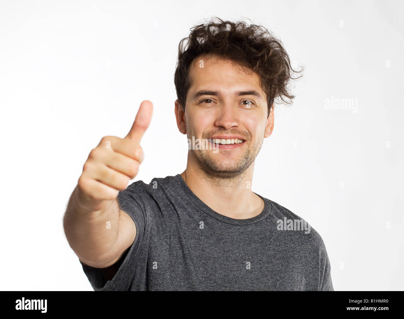Young man and okey sign isolated on white background Stock Photo - Alamy