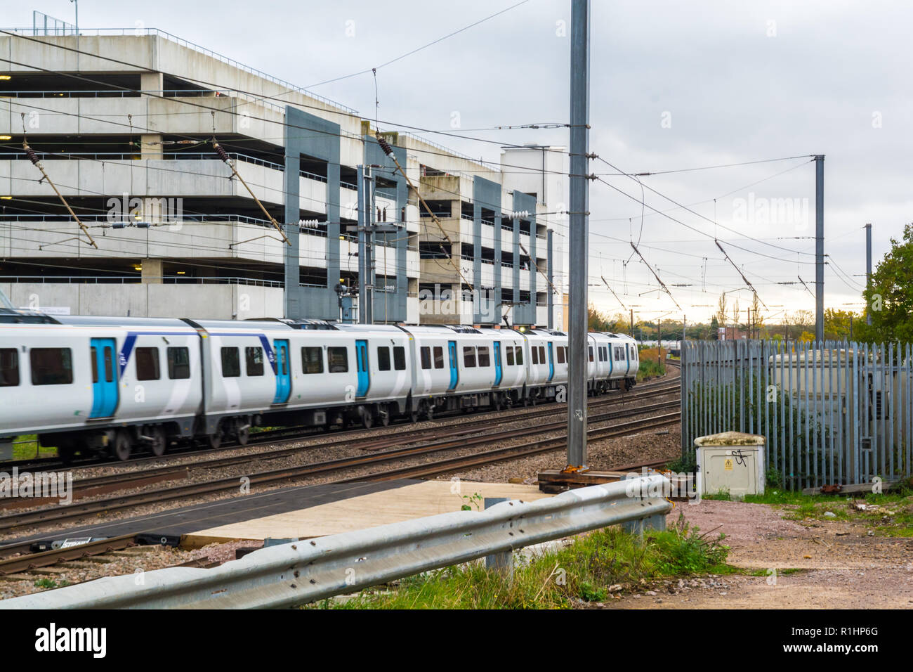 Passenger train moving through a city landscape Stock Photo - Alamy