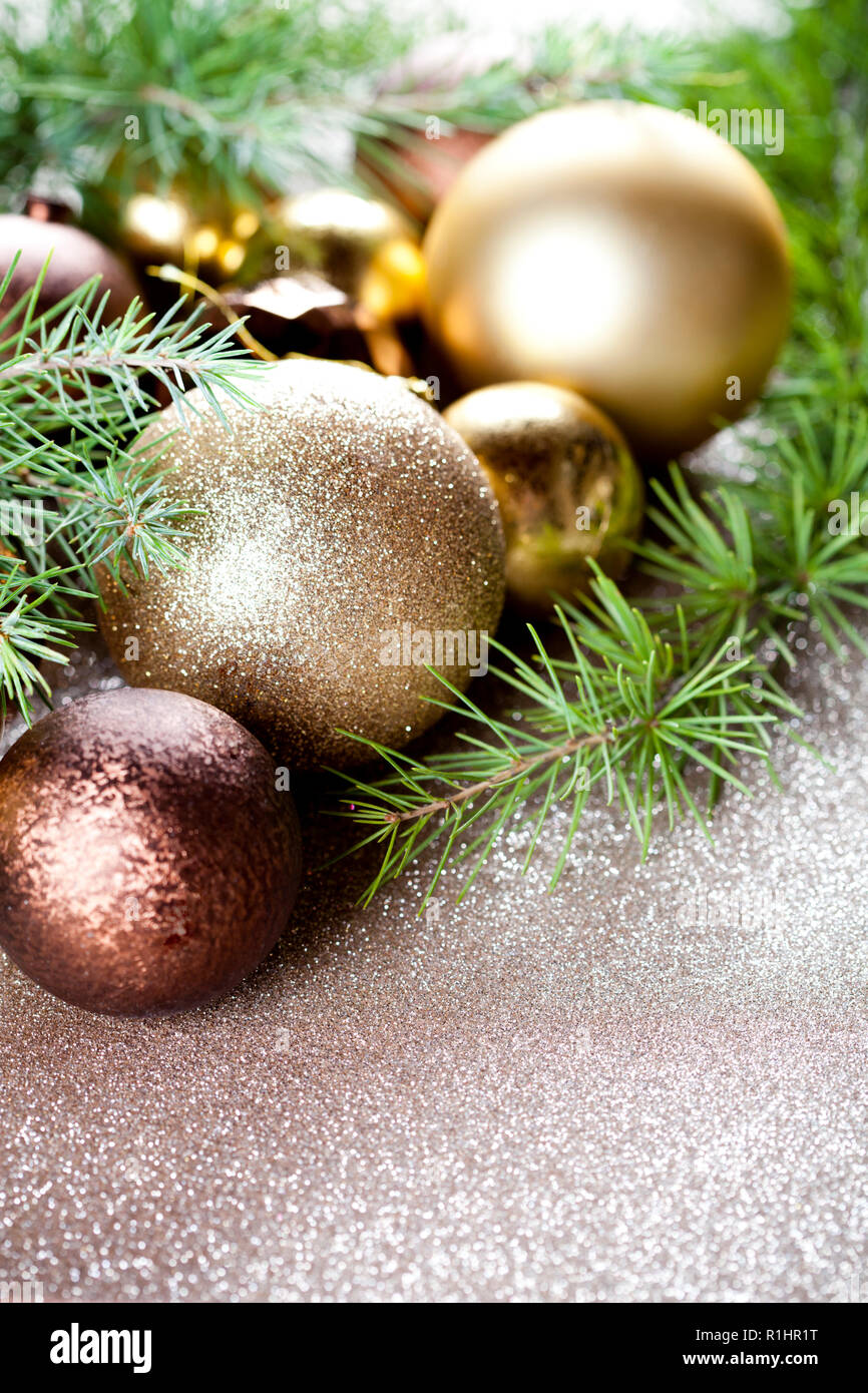 Christmas decorations and evergreen fir tree branch closeup on gold ...