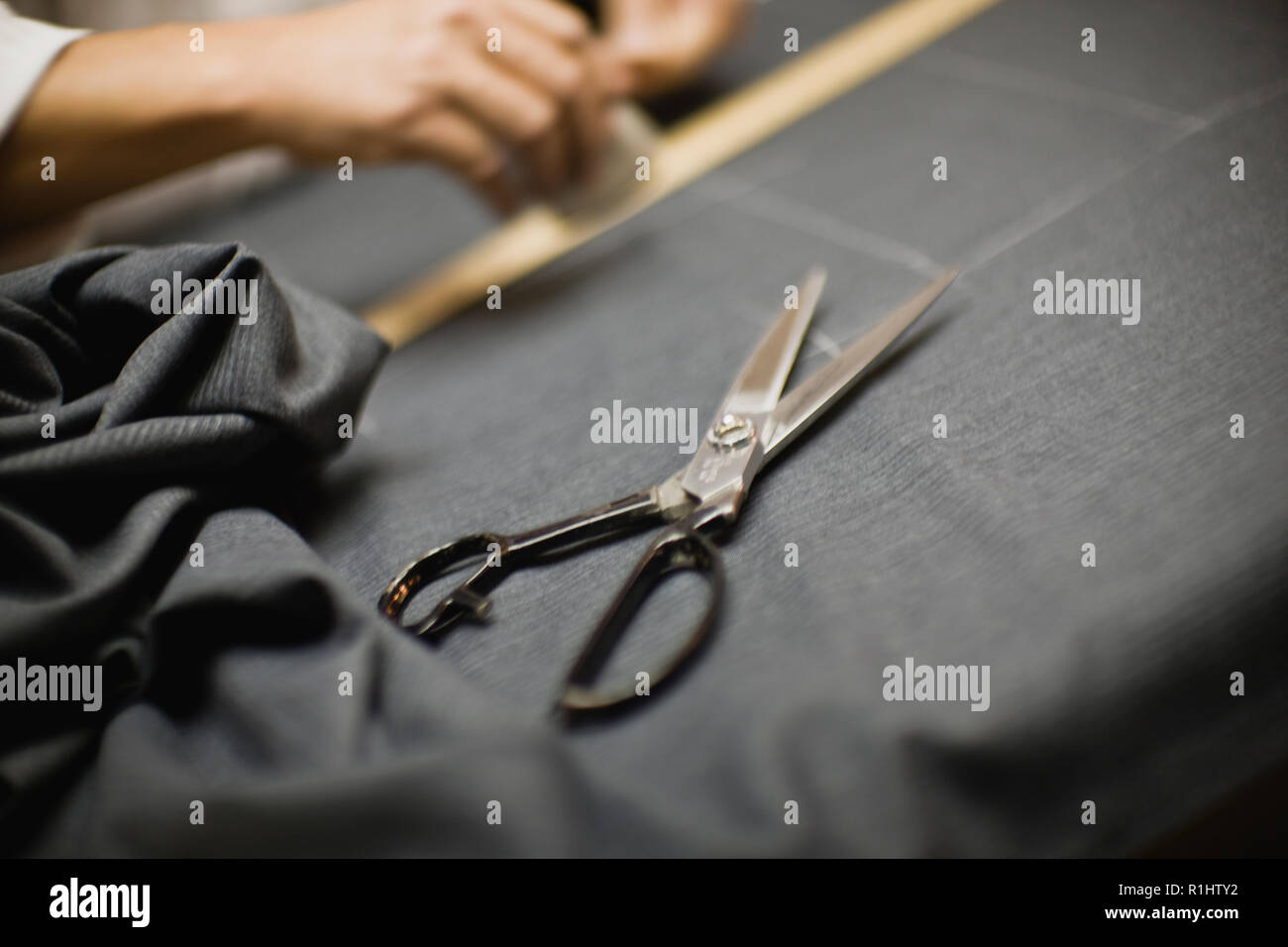Dressmaking scissors on top of suiting material Stock Photo - Alamy