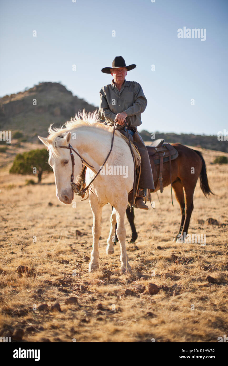 Portrait of a rancher sitting on a horse Stock Photo - Alamy
