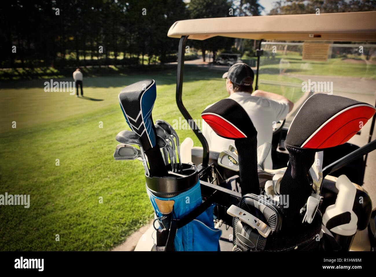 Golf clubs inside a golf bag in the back of a golf cart at a golf ...