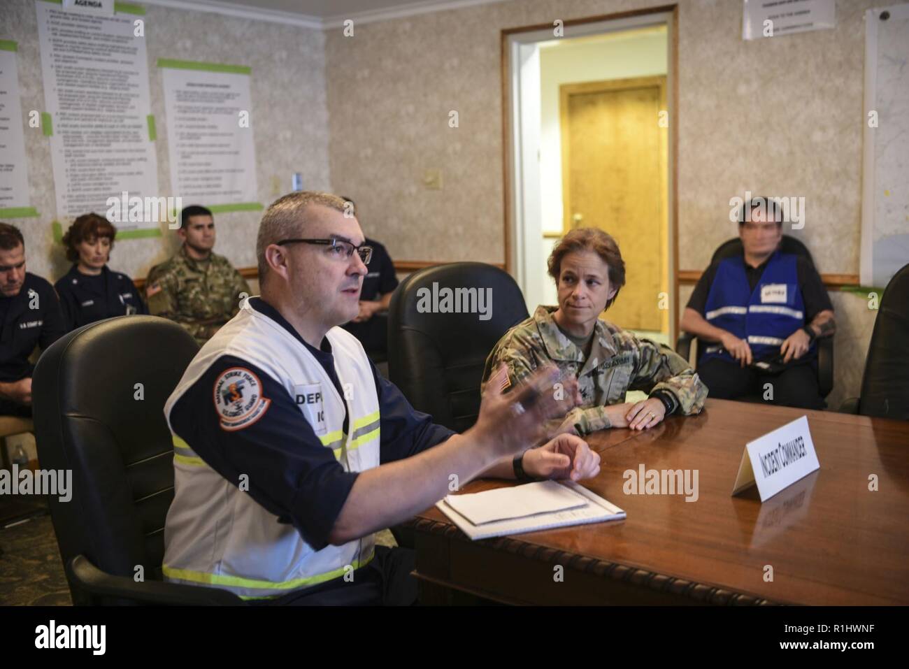 U.S. Coast Guard Cmdr. Chris Cederholm gives a briefing in a planning ...