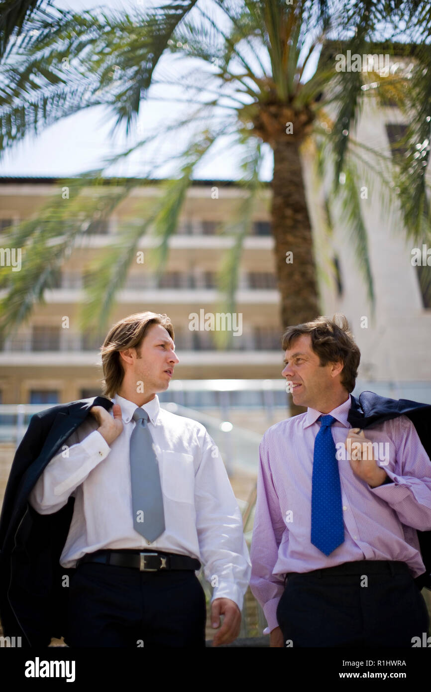 Two businessmen walking down steps in the city Stock Photo - Alamy