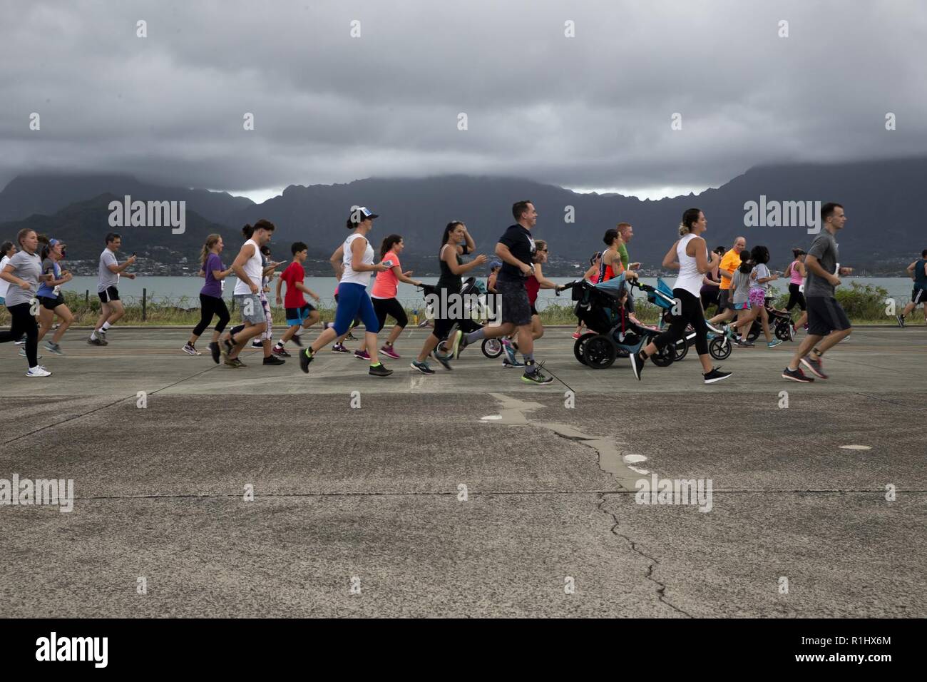 Participants run across the flight line aboard Marine Corps Air Station ...