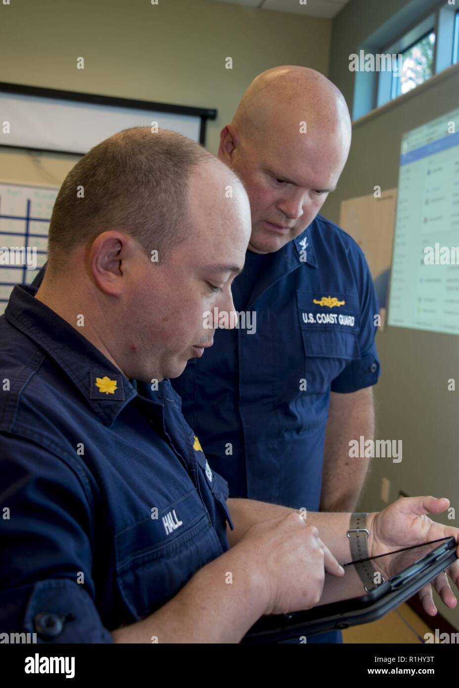 Coast Guard Capt. John Reed (background) commander, Coast Guard Sector ...