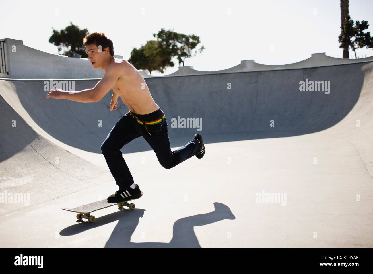 Teenage boy skating at skate park Stock Photo - Alamy
