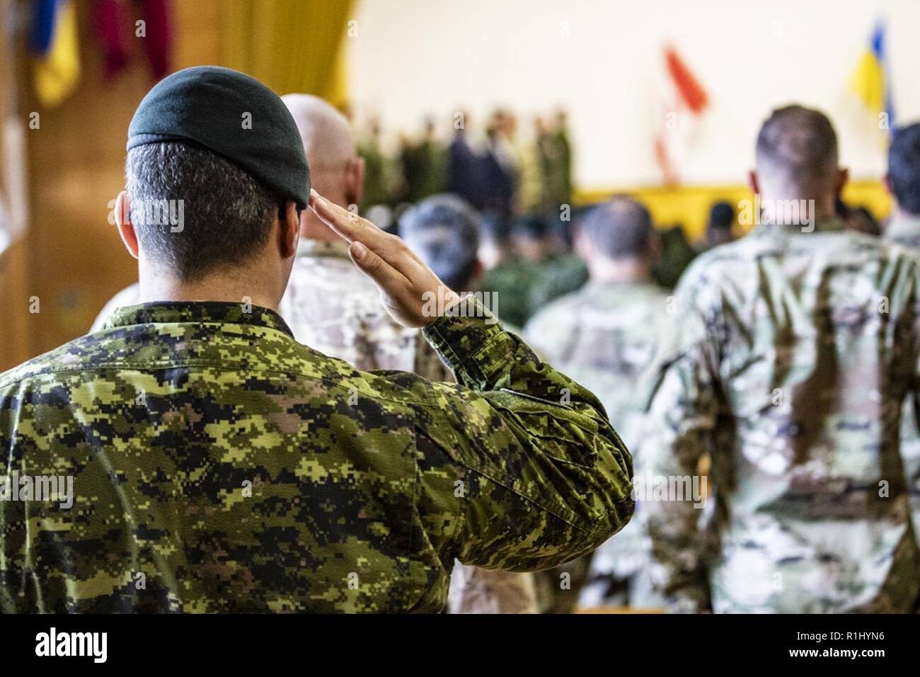 A Canadian Soldier salutes as the Canadian National Anthem is played ...