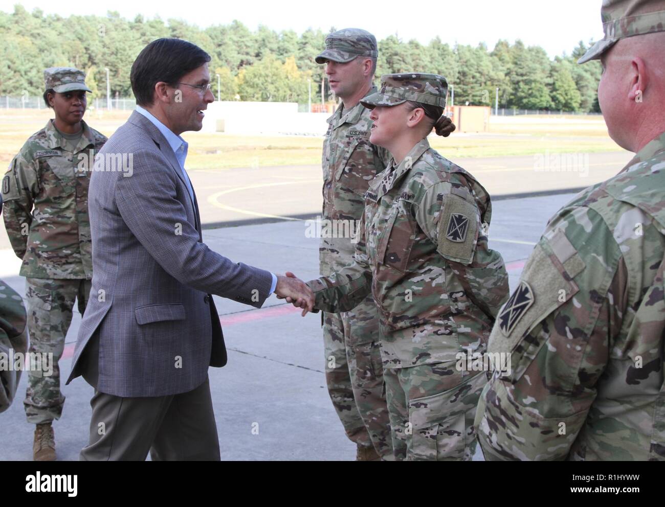 The Secretary of the Army Mark Esper presents a coin to Sgt. Shelbi ...