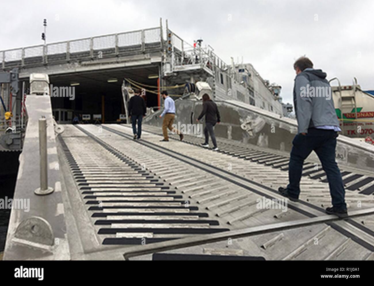 Naval Undersea Warfare Center Division Newport employees walk up a ramp ...