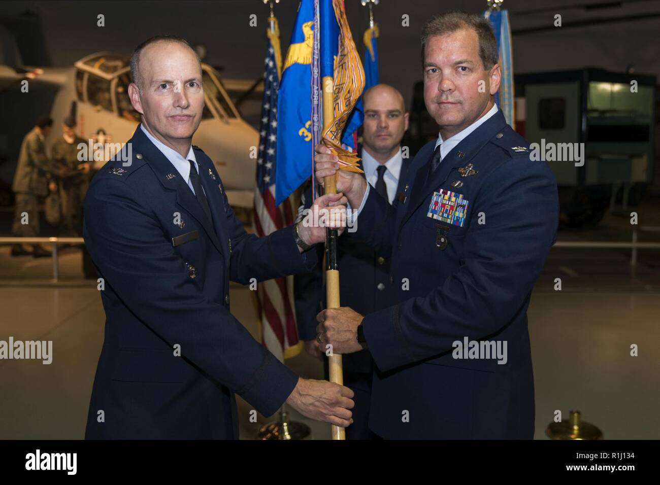 Col. Sterling Tree, right, passes the 339th Flight Test Squadron guidon ...