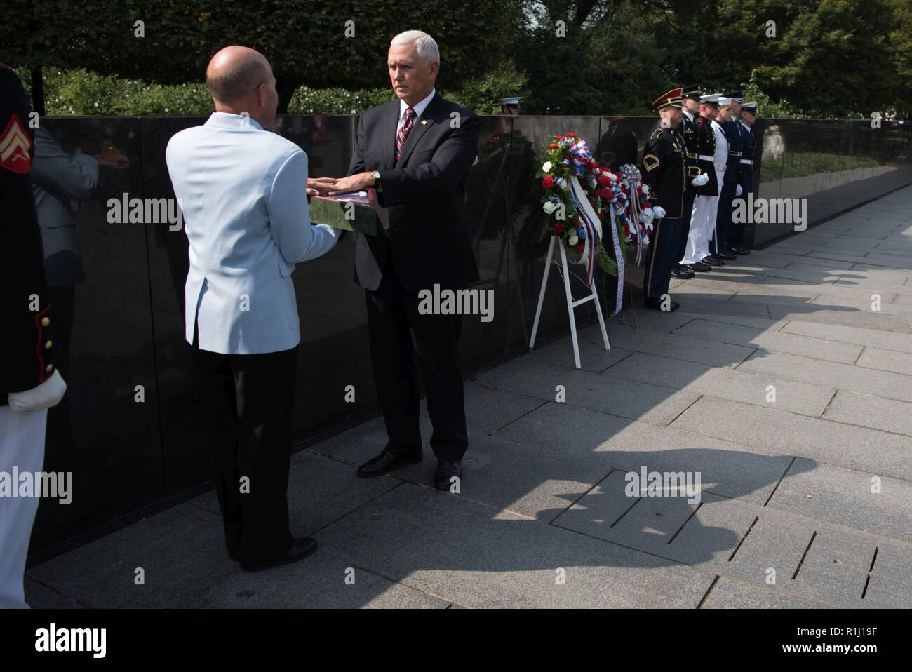 U.S. Vice President of the United States Michael Pence presents a flag ...