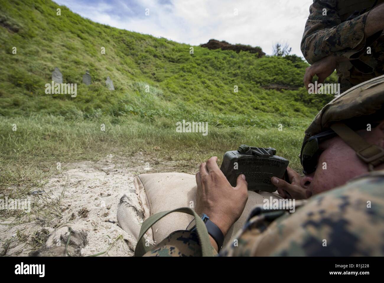 A U.S. Marine aims a M18A1 Claymore mine at targets during demolition ...