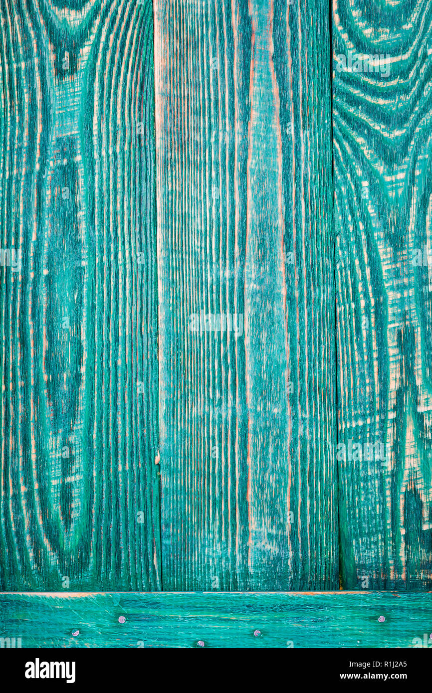Vertical background of three green wooden boards fastened by a ...