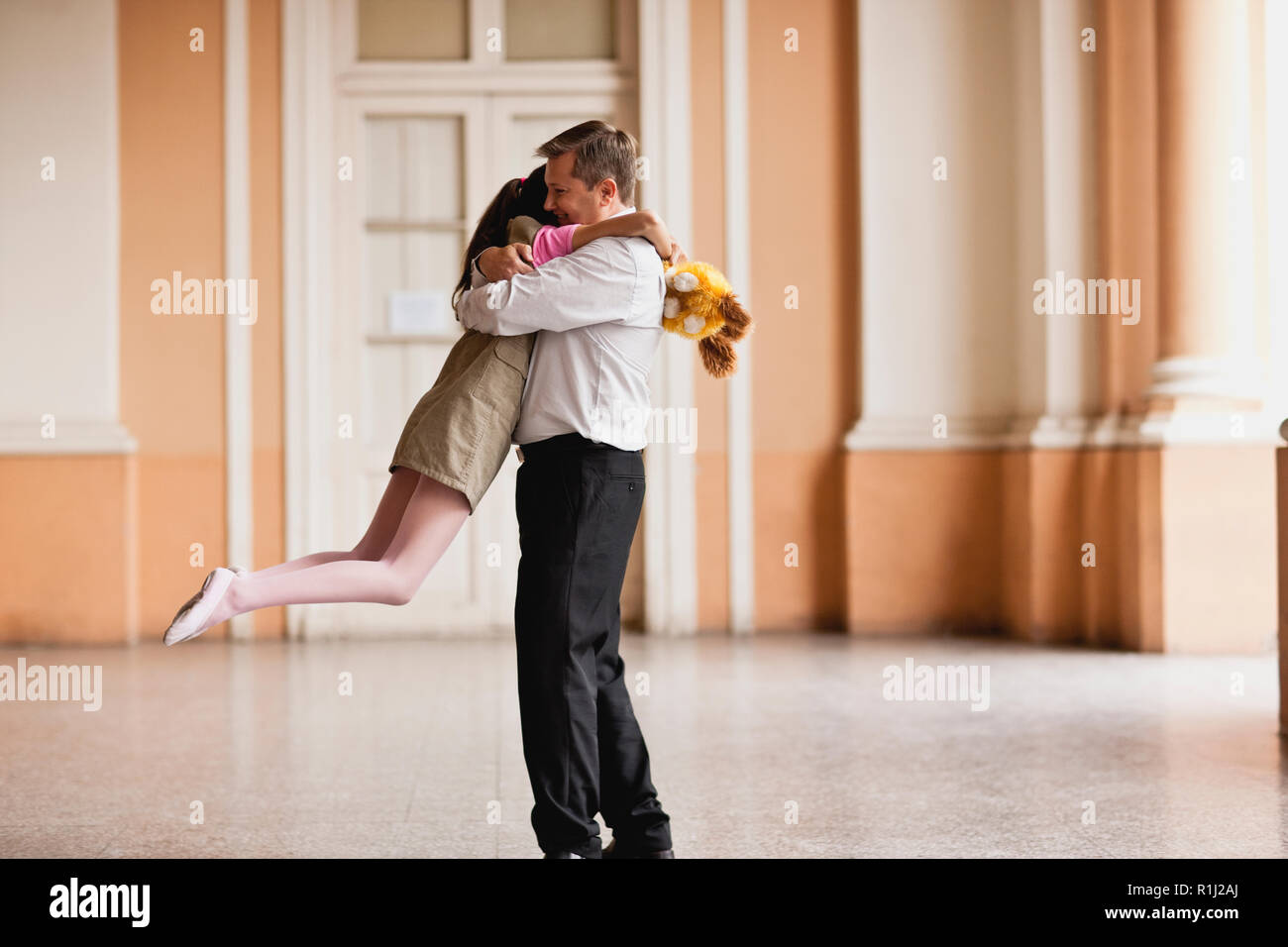Man happily hugging his daughter Stock Photo - Alamy