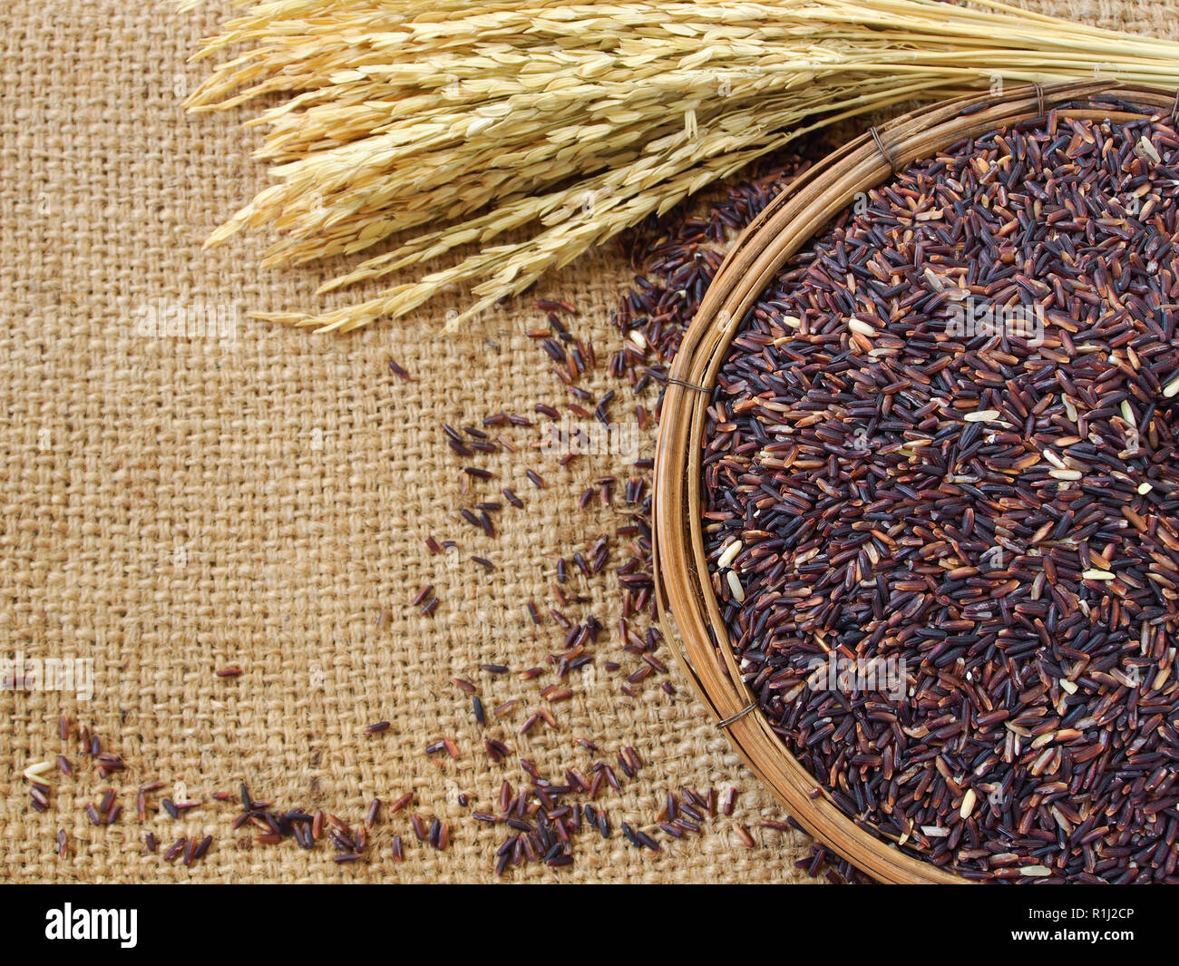 riceberry in basket with rice on sack background Stock Photo - Alamy