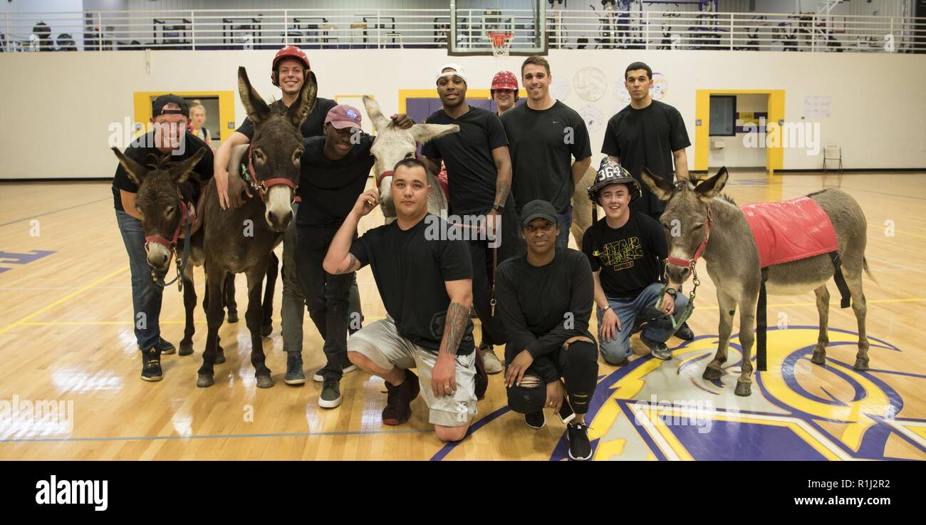 Schriever Airmen gather for a photo with their furry teammates after ...