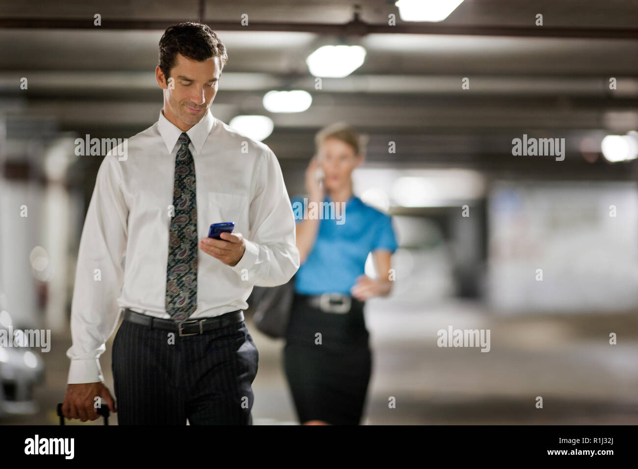 Cell phones people walking looking down hi-res stock photography and ...
