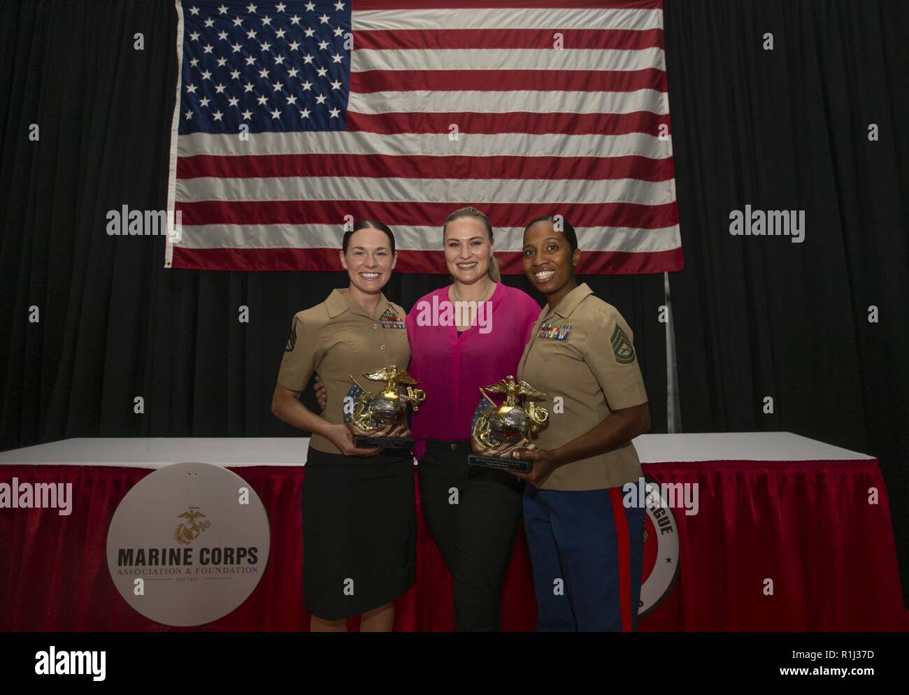 Recipients of the Enlisted Awards pose with family and friends for a ...
