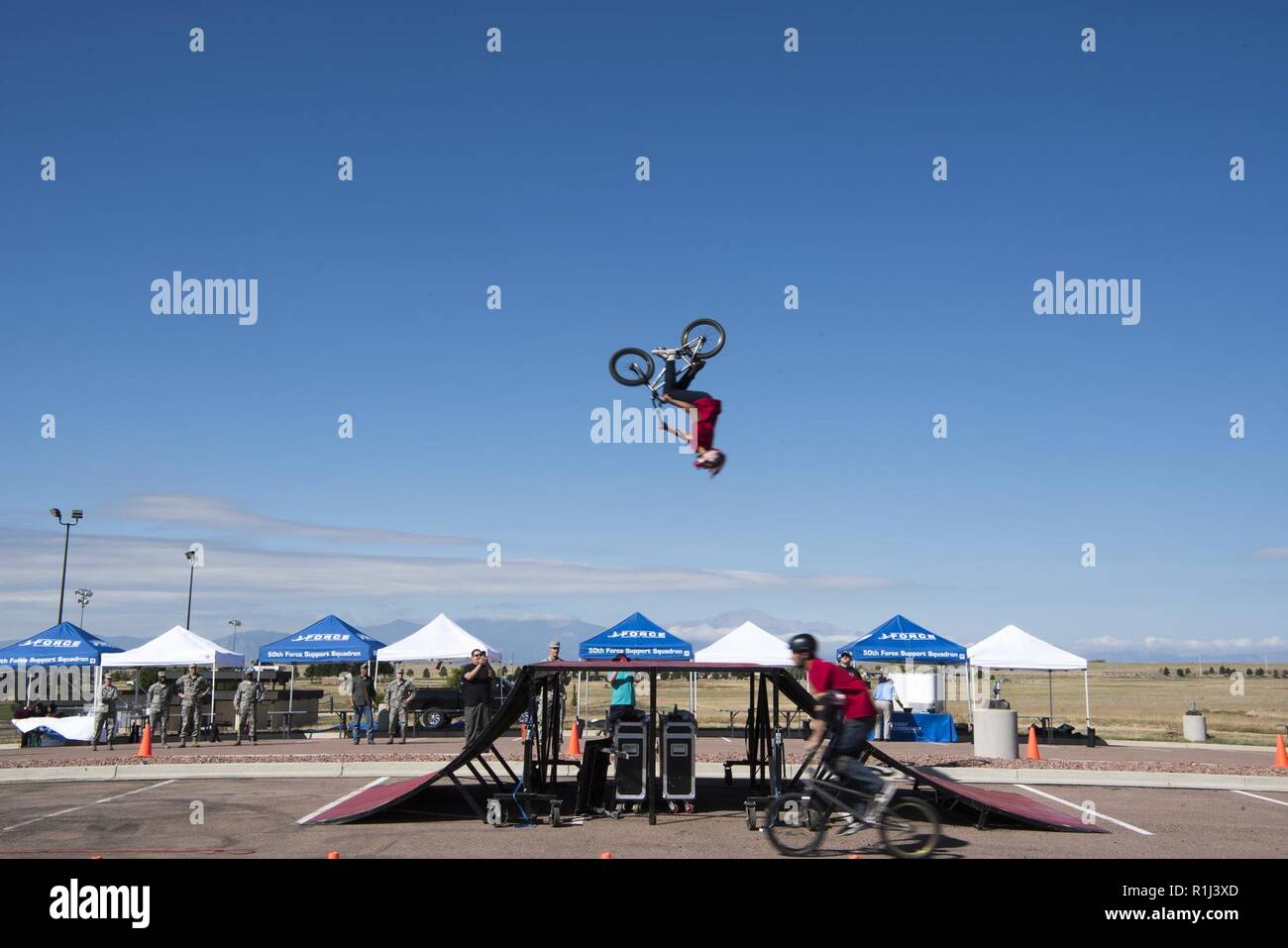 A member of the Superhero Stunt Team performs a backflip for Schriever ...