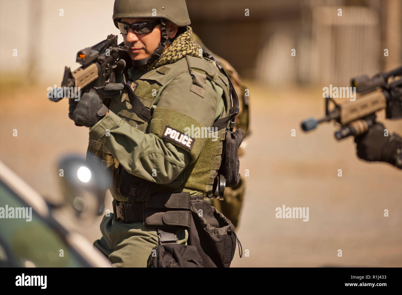 Male police officer aiming a gun toward a target during an exercise at ...