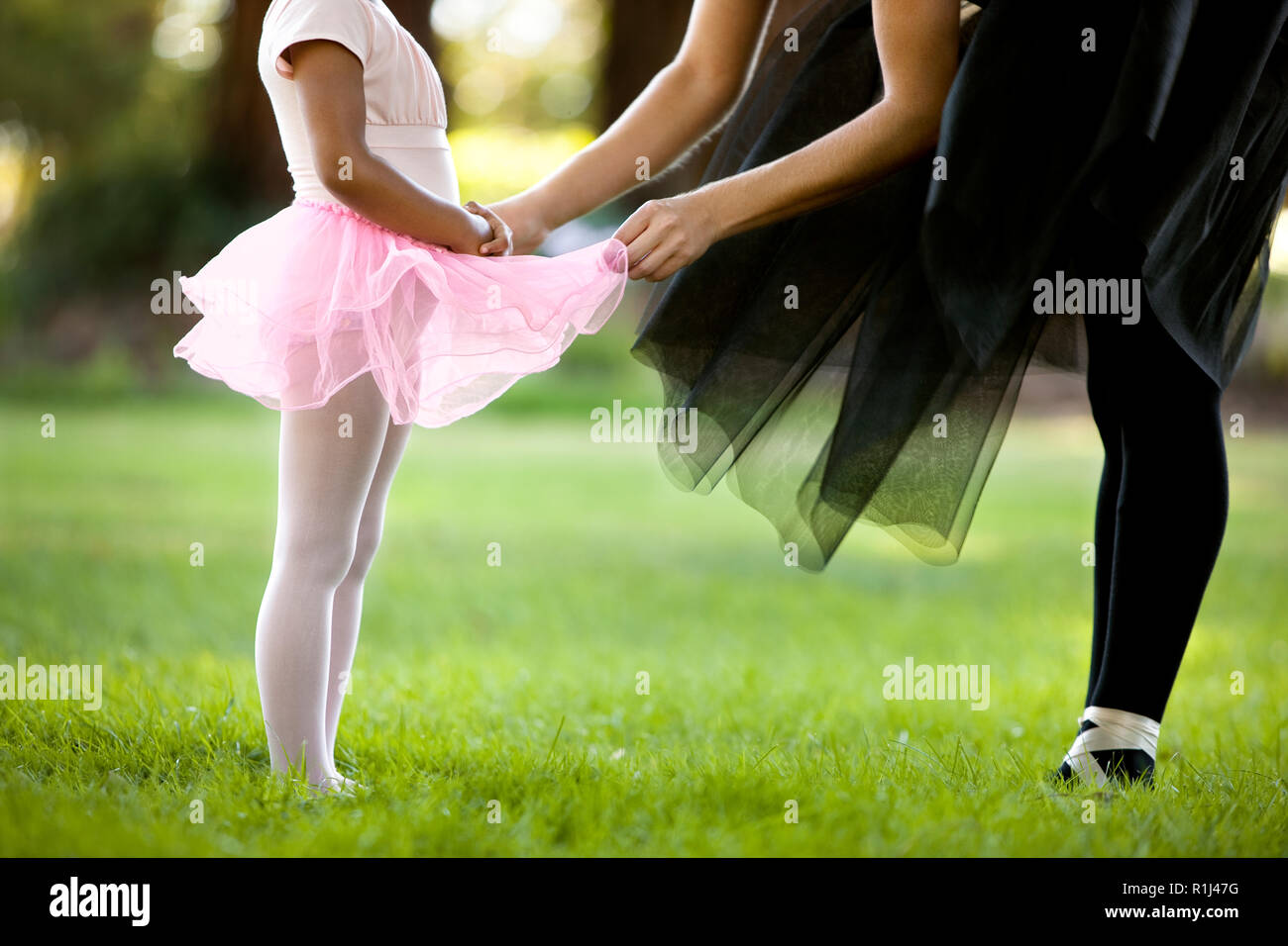 Mid adult woman and her young daughter ballet dancing in a park Stock ...