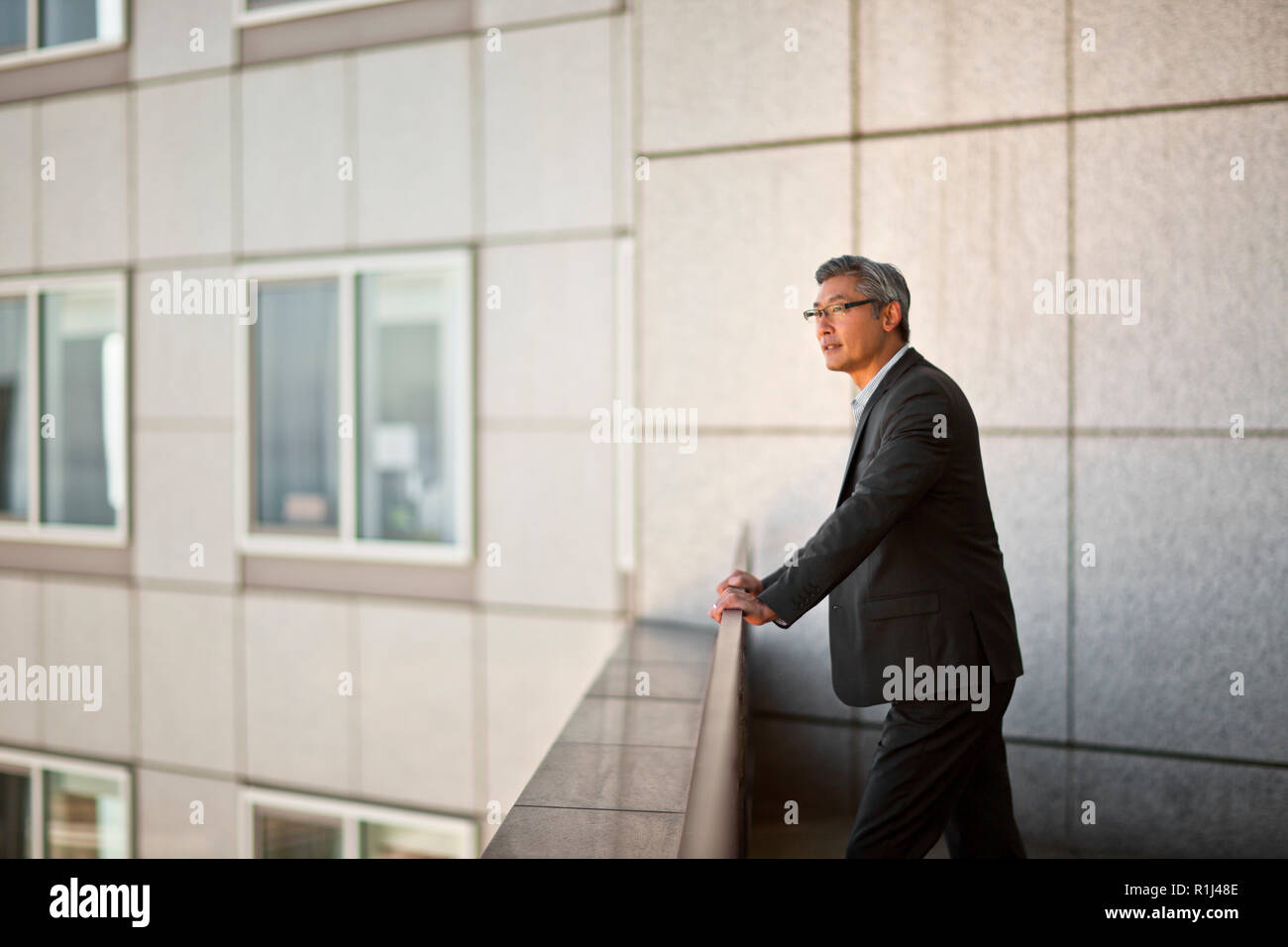 Asian businessman stands on hi-res stock photography and images - Alamy
