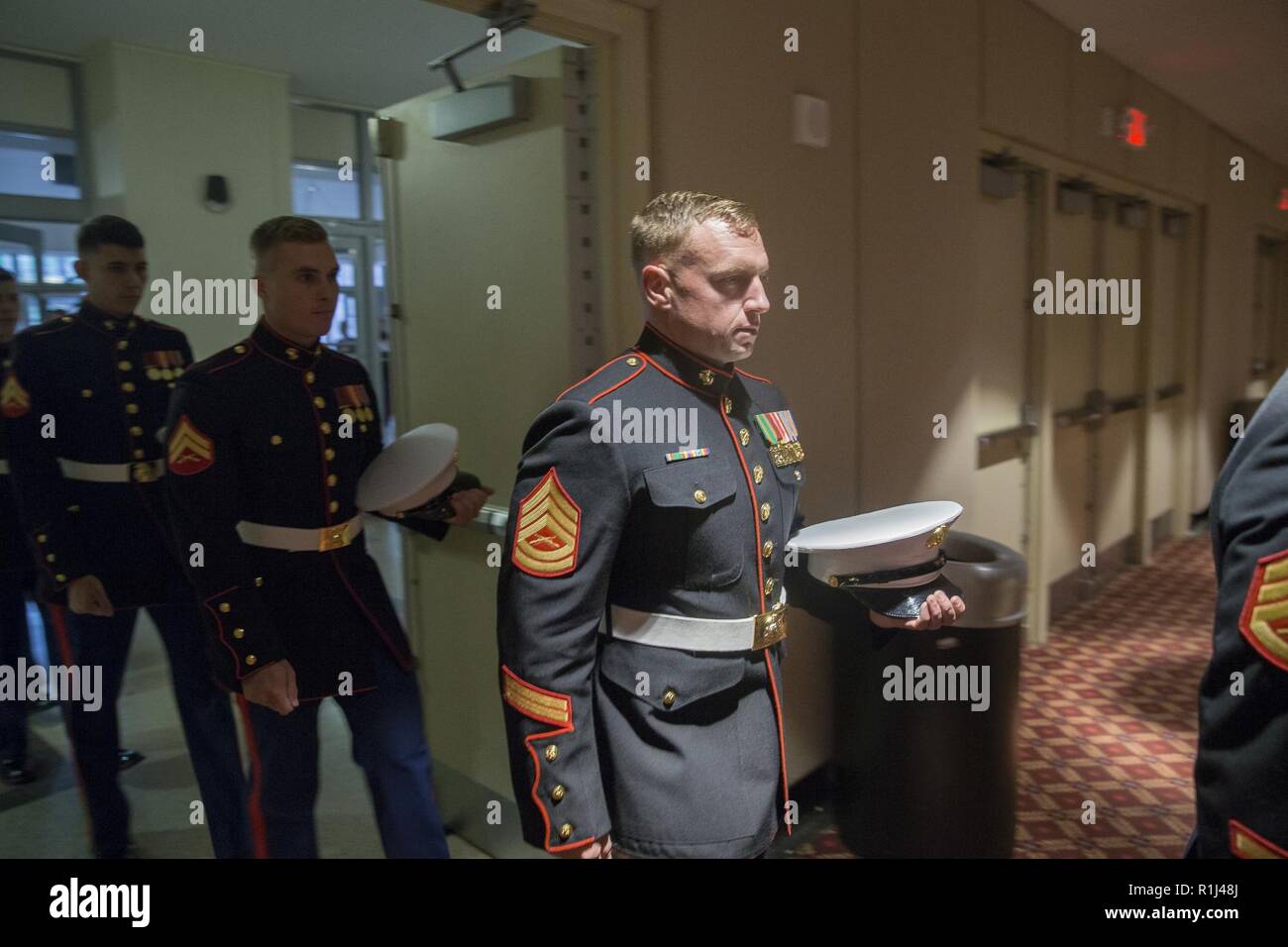 U.S. Marines march toward their seats during a graduation for Marine ...