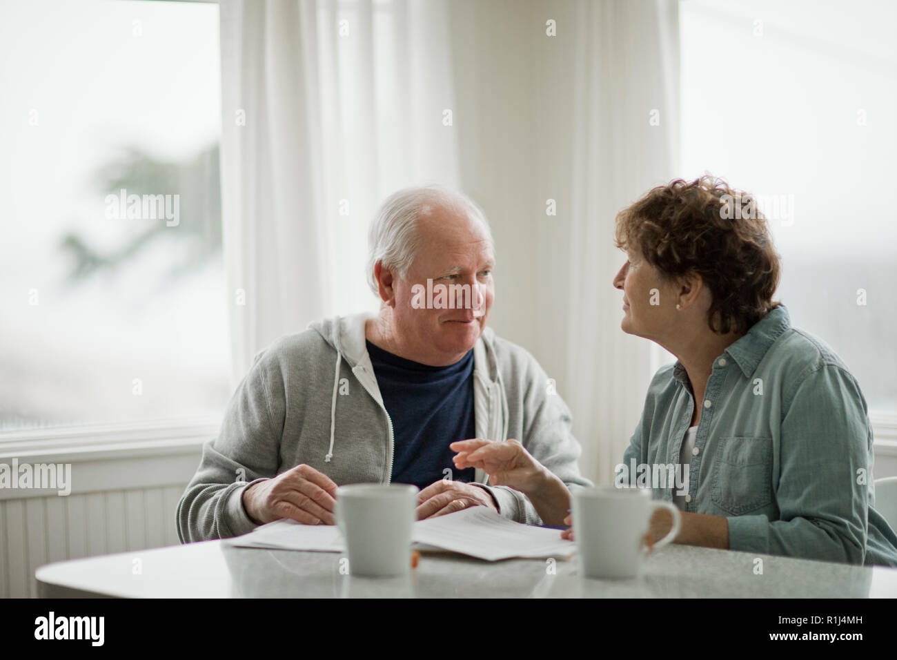 Senior couple looking over important documents Stock Photo - Alamy