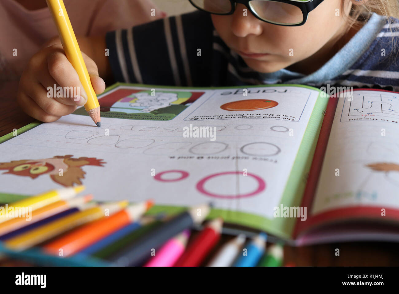Toddler working hard on homework and practicing writing Stock Photo - Alamy