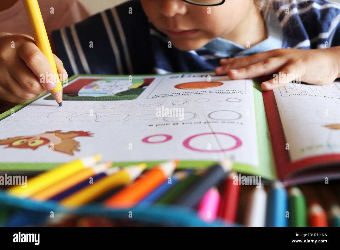 Toddler working hard on homework and practicing writing Stock Photo - Alamy