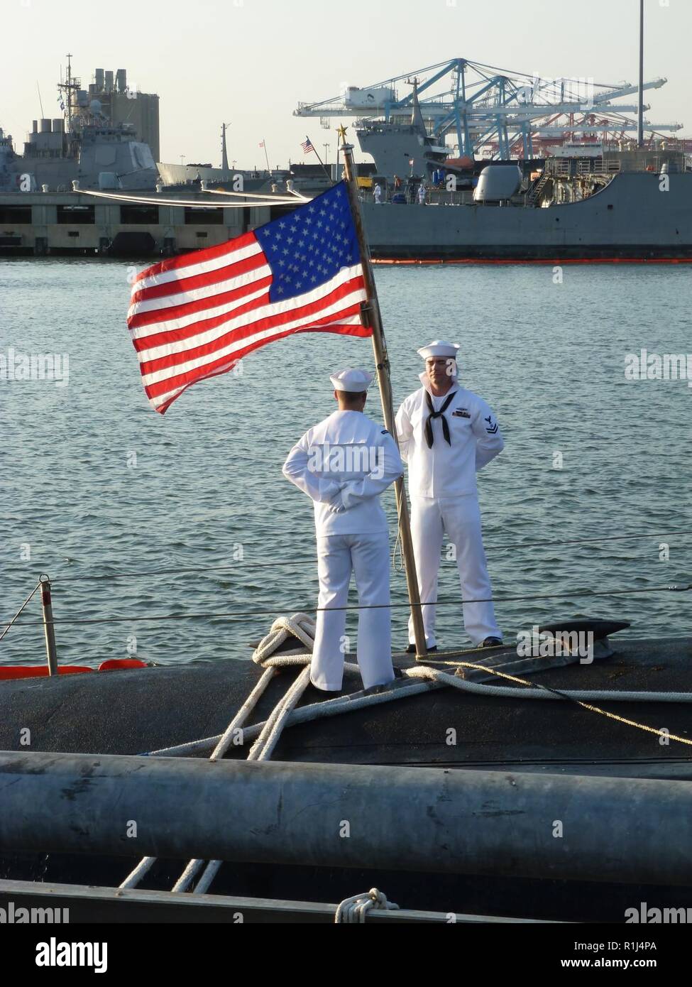 Sailors stationed on USS John Warner (SSN 785) raise the Ground Zero ...