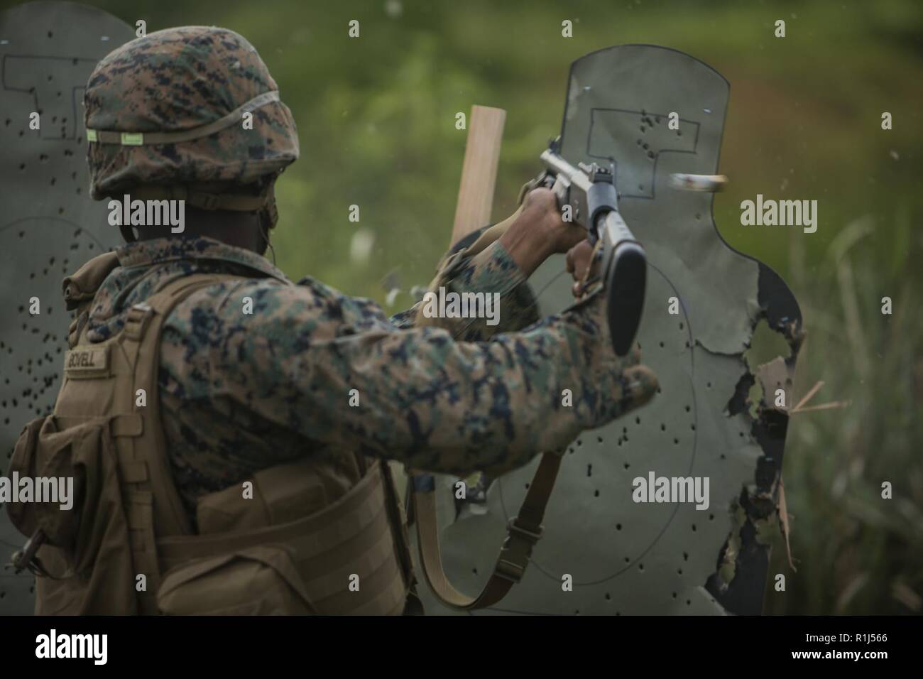 Lance Cpl. Shakeel Bovell fires an M1014 shotgun in a breaching stance ...