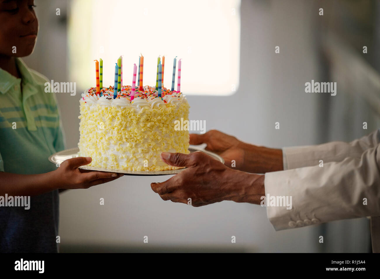 Boy giving his grandfather a birthday cake Stock Photo - Alamy