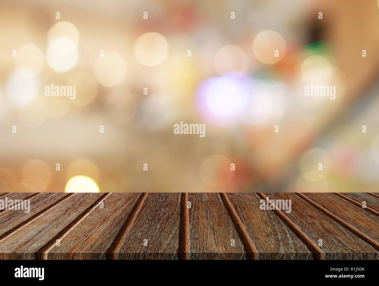 Empty perspective wood plank table top with abstract bokeh light ...