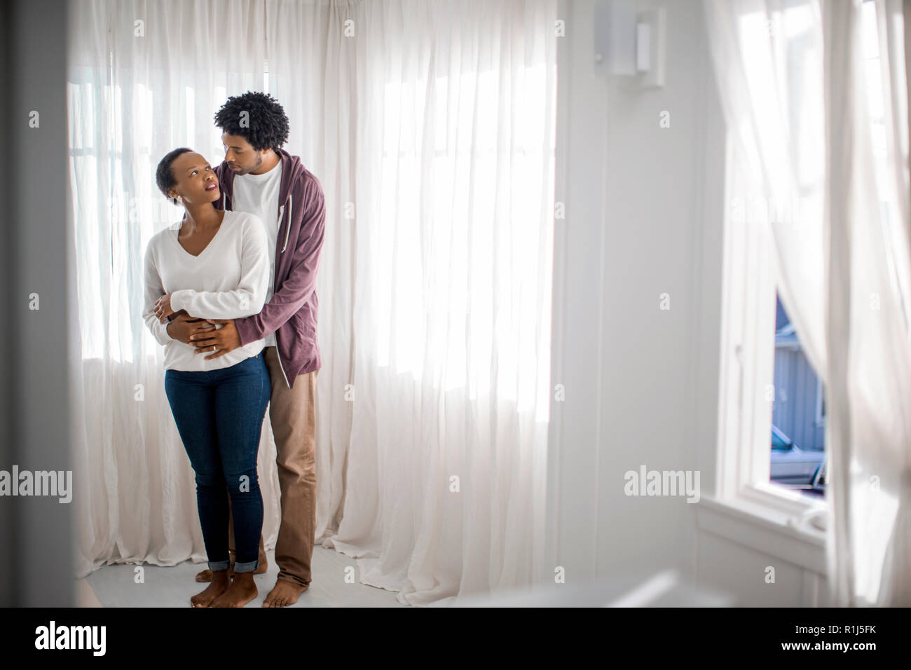 Happy young man embracing his beautiful partner Stock Photo - Alamy