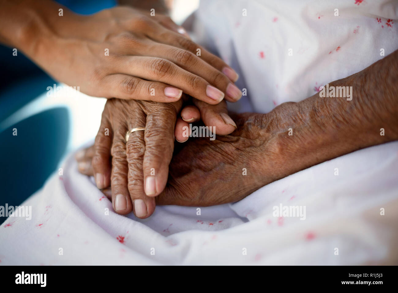Grandmother being consoled by grandaughter Stock Photo - Alamy
