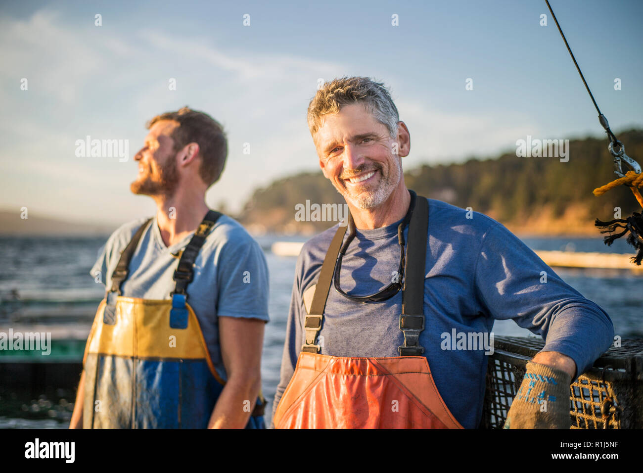 Father and son operating fishing business Stock Photo - Alamy