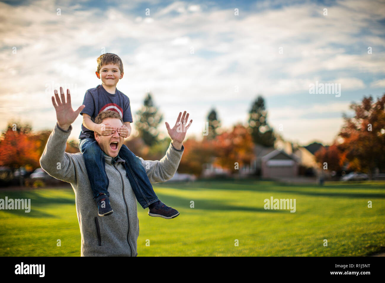 Boy having piggyback ride on his father's shoulders Stock Photo - Alamy