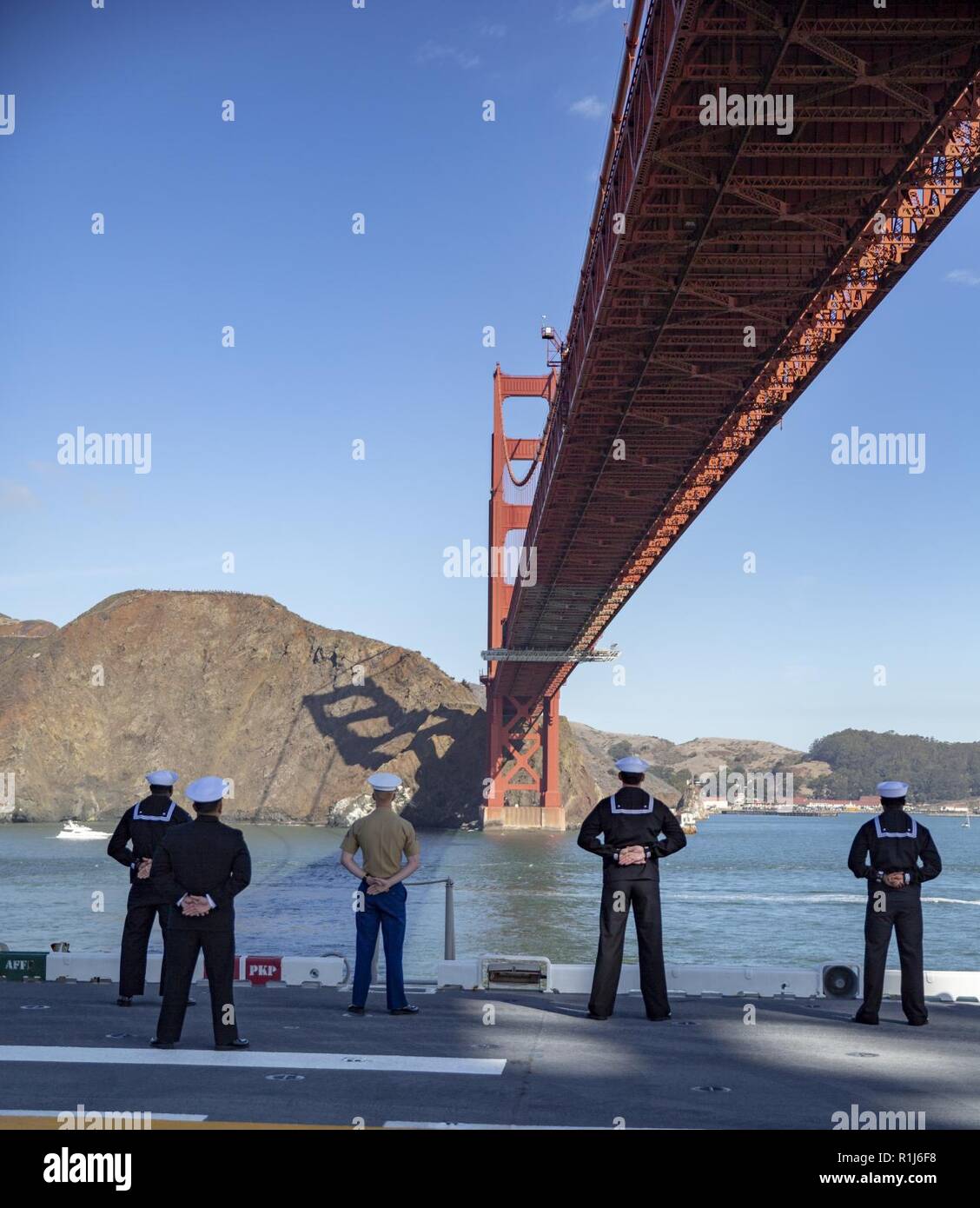 A Marine and Sailors aboard the USS Bonhomme Richard conduct the ...