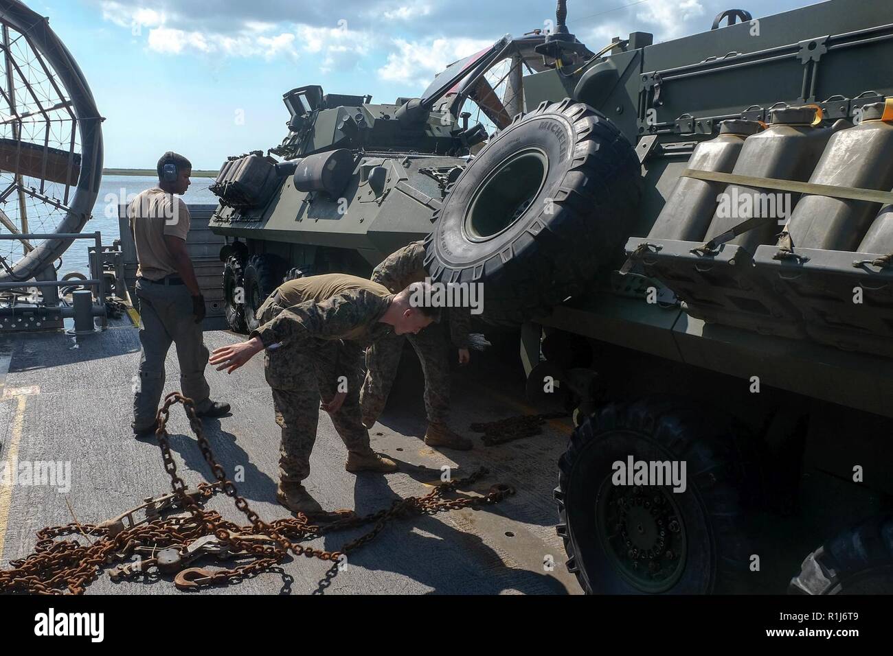 U.S. Marines remove restraining chains from their Light Armored ...