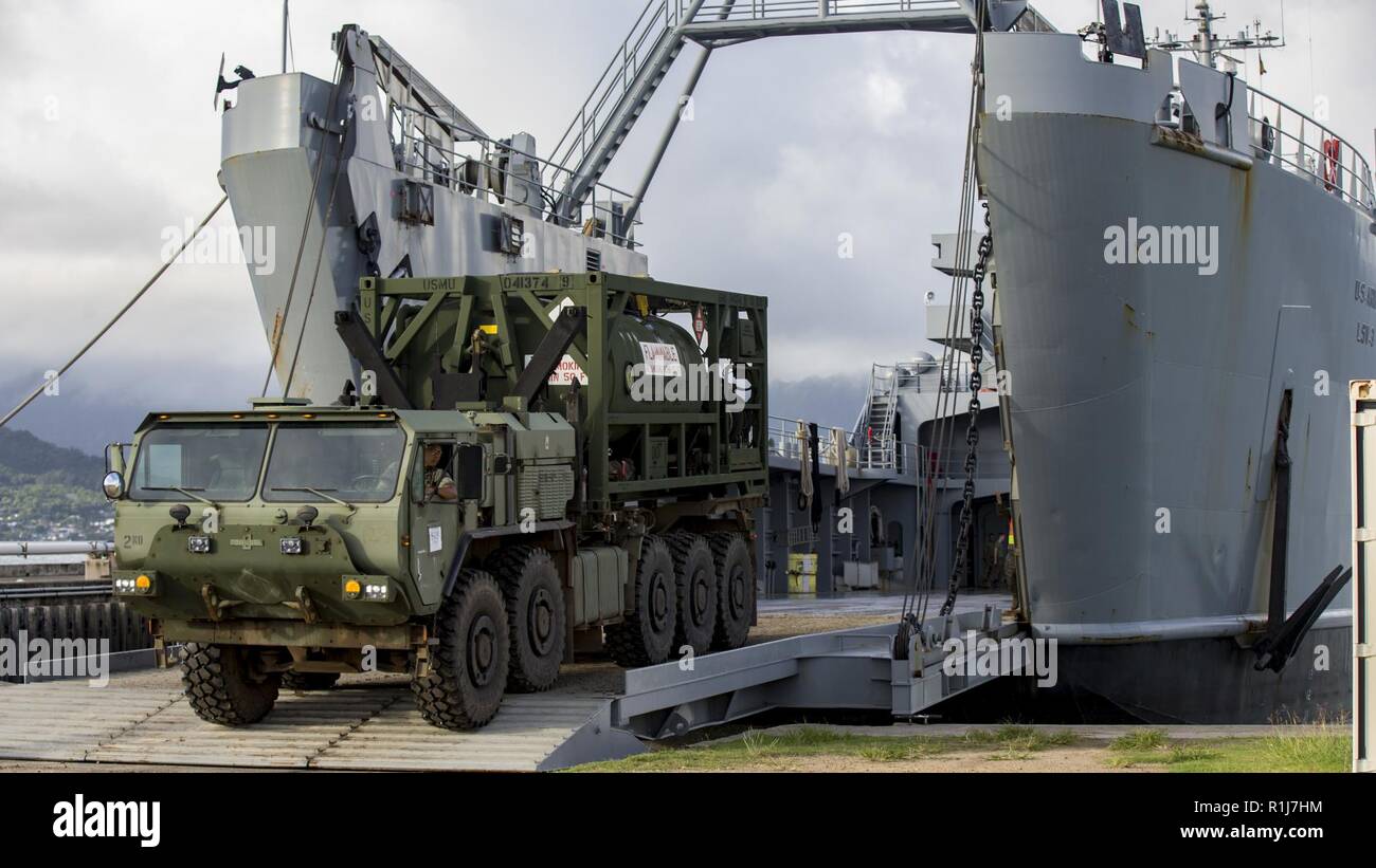 U.S. Marines with Combat Logistics Battalion 3 (CLB-3) load a 7-ton ...