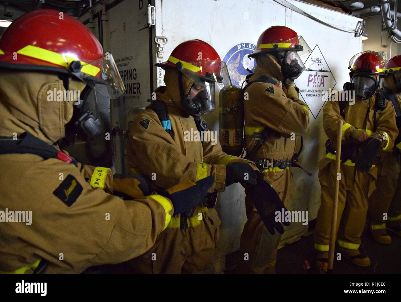 PHILIPPINE SEA (Oct. 8, 2018) - Sailors don firefighting gear during a ...