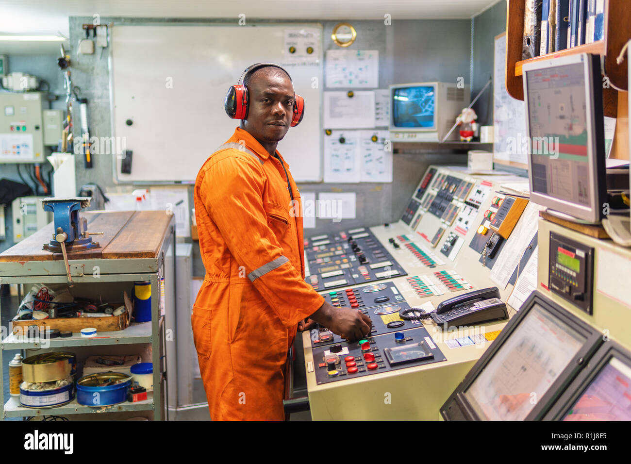 Marine engineer officer working in engine room Stock Photo - Alamy